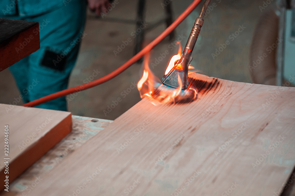 Details of burning wood tecniques during work session for customized ...