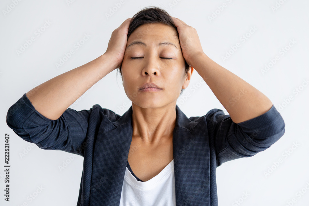 Worried Asian business woman clutching head. Tired lady standing with ...