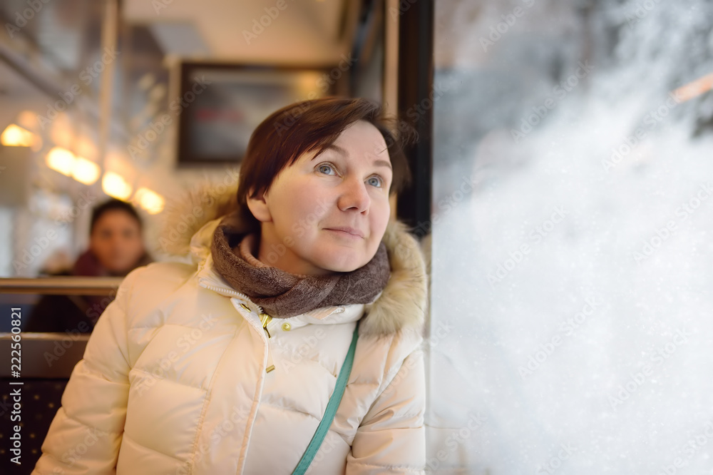 Woman looking out of the window of train during travel on cogwheel ...