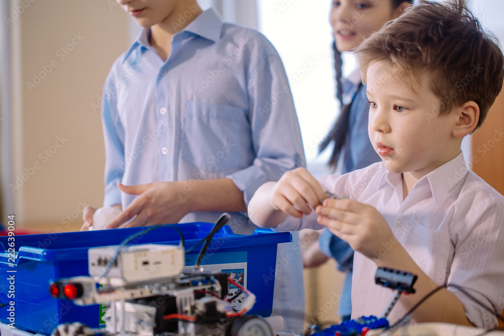 Adorable blonde boy with his older friends visit kids show where they ...