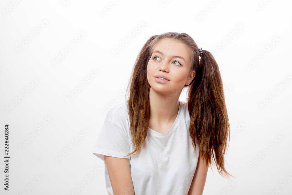lovely girl with pensive expression looking up, copy space, isolated ...