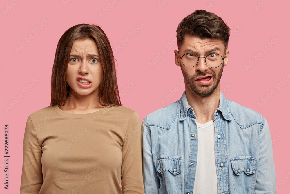 Fotografia do Stock: Puzzled Caucasian students clench teeth in ...