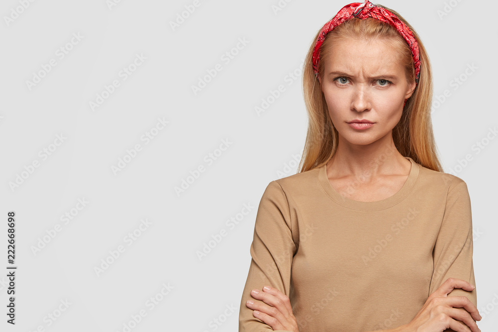 Insulted displeased blonde woman frowns face, has bothered expression ...