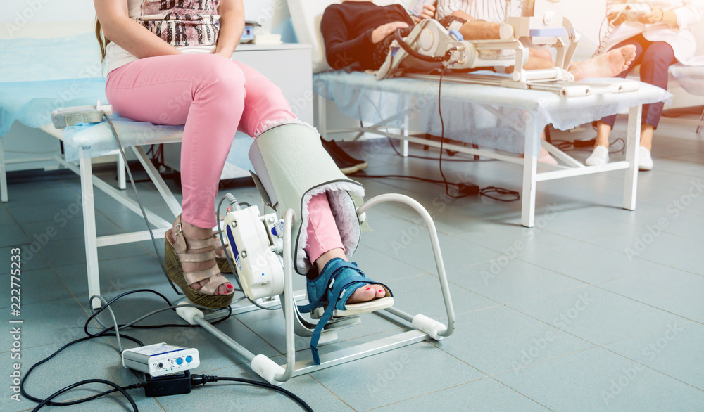 Patient on CPM (continuous passive range of motion) machines. Device to ...