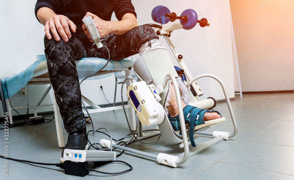 Patient on CPM (continuous passive range of motion) machines. Device to ...