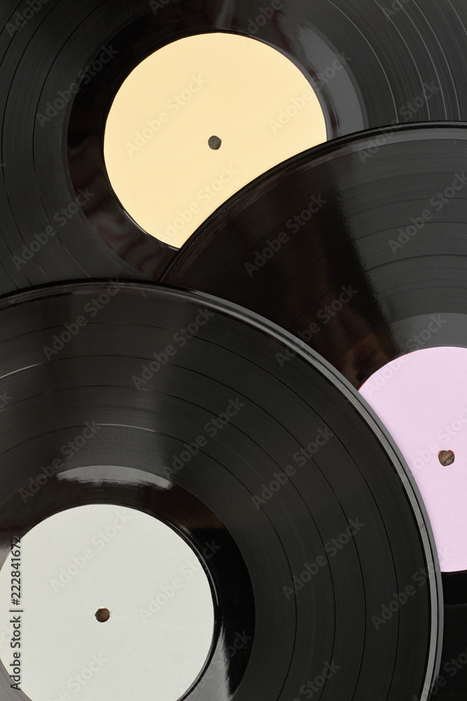 Vinyl records background. Close up vinyl records with different labels ...