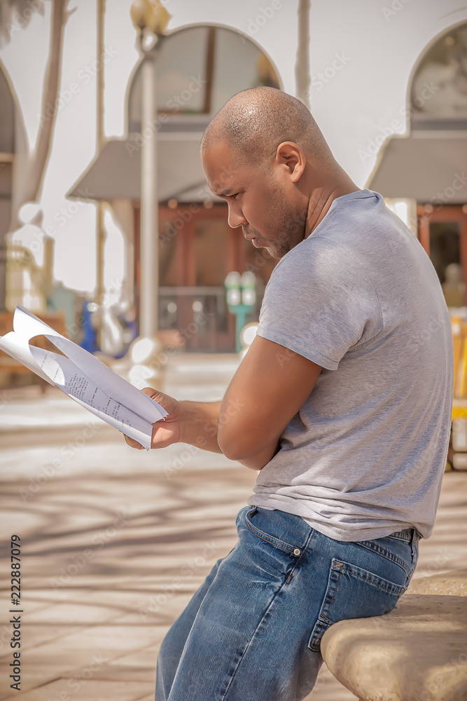African American black man is reading his script for the audition ...