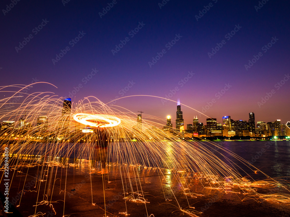 Beautiful photograph of a steel wool spark spinner along Lake Michigan ...