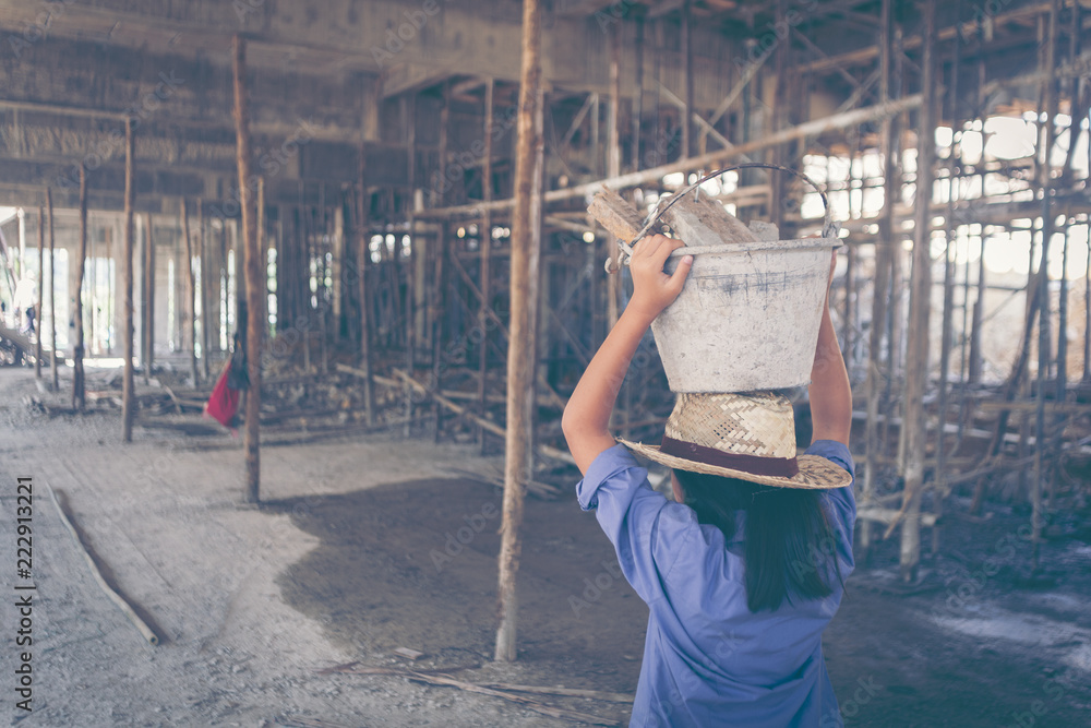 Little girl labor working in commercial building structure, World Day ...
