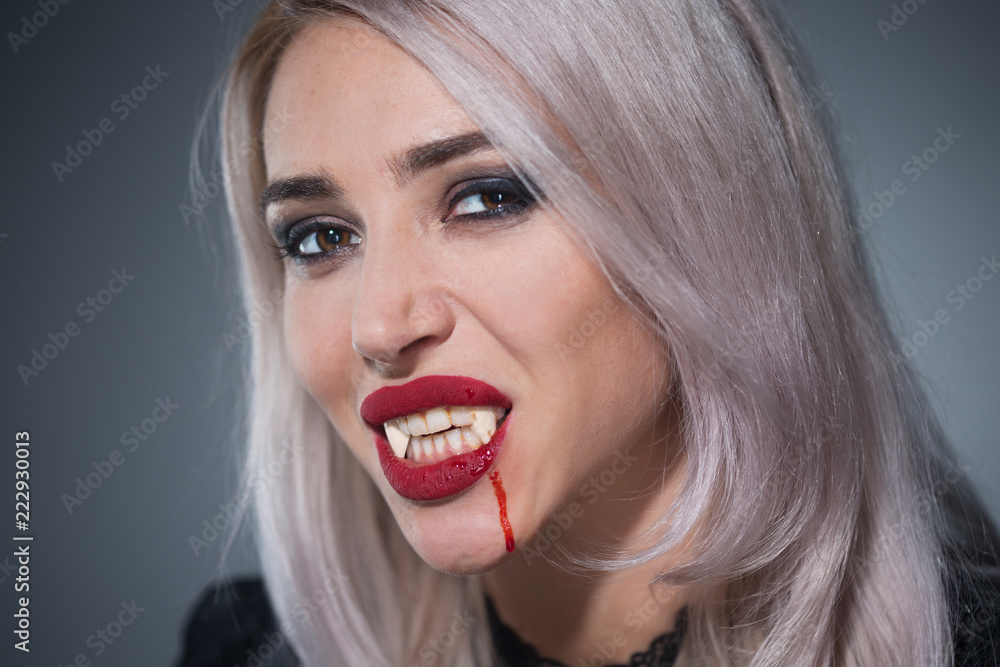 portrait of vampire woman with a bloody mouth and teeth fangs ...