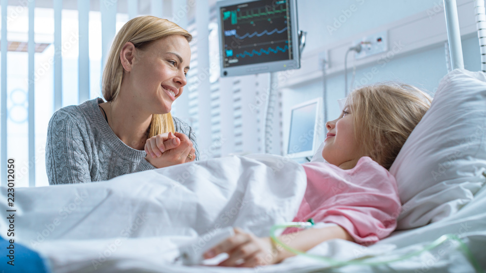 Cute Little Girl Lies on a Bed in the Children's Hospital, Her Mother ...