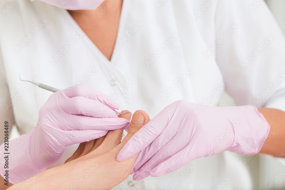 Professional pedicure using special double nail intrument.Patient ...