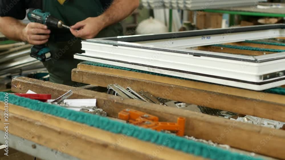 Production and manufacturing of pvc windows, the male worker assembles ...