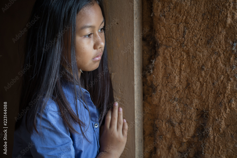Portrait of a poor little thailand girl lost in deep thoughts, poverty ...