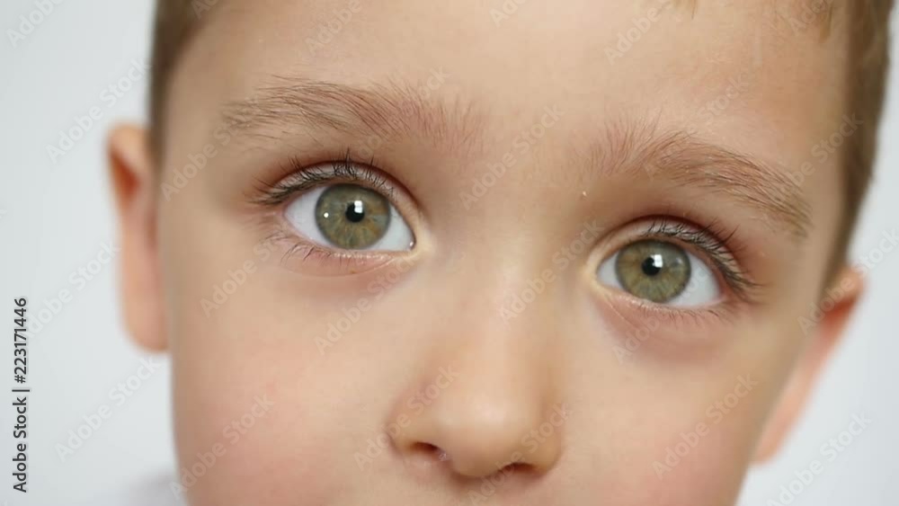 Close-up: the eyes of a child. The boy looks thoughtfully Stock Video ...