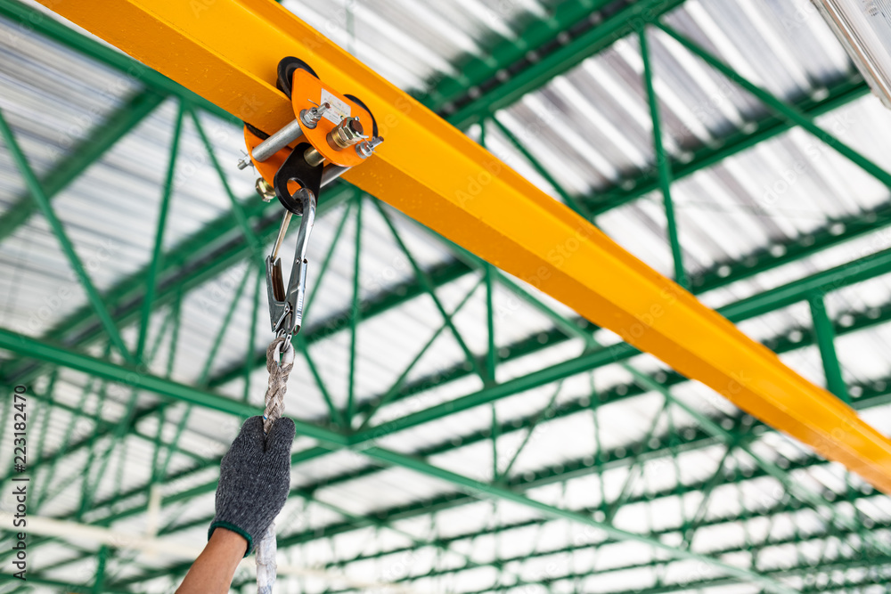 Construction worker wearing safety harness and safety line working at ...