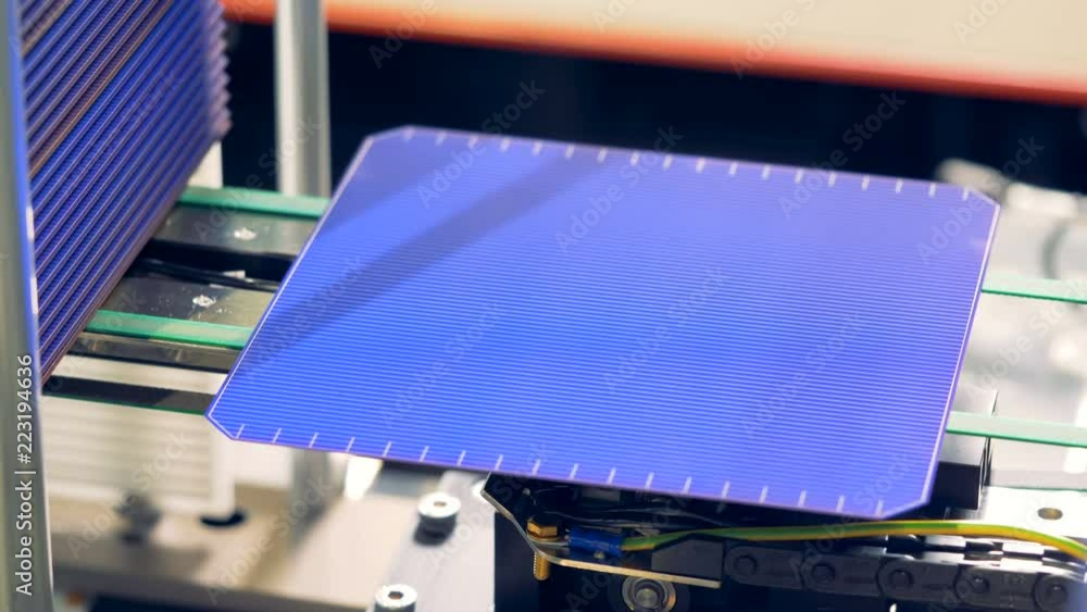 Solar module cells being released and moving along the conveyor belt ...