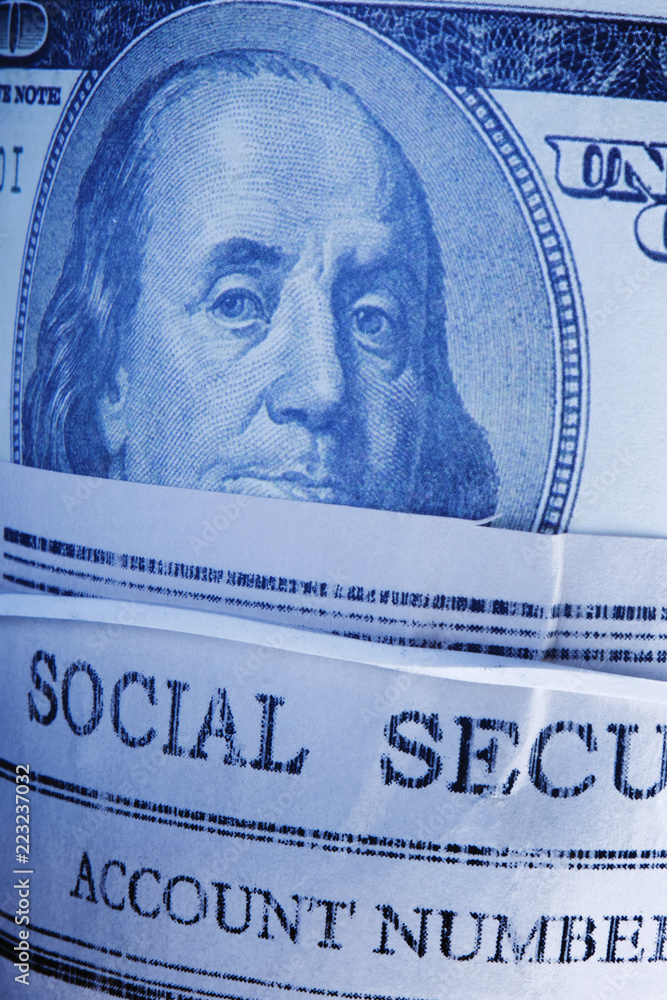 Close Up Of Social Security Card Rolled Up With Money Roll Currency