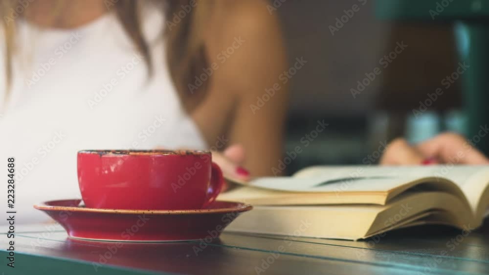 Reading book and having coffee in front of a coffee house Stock Video ...