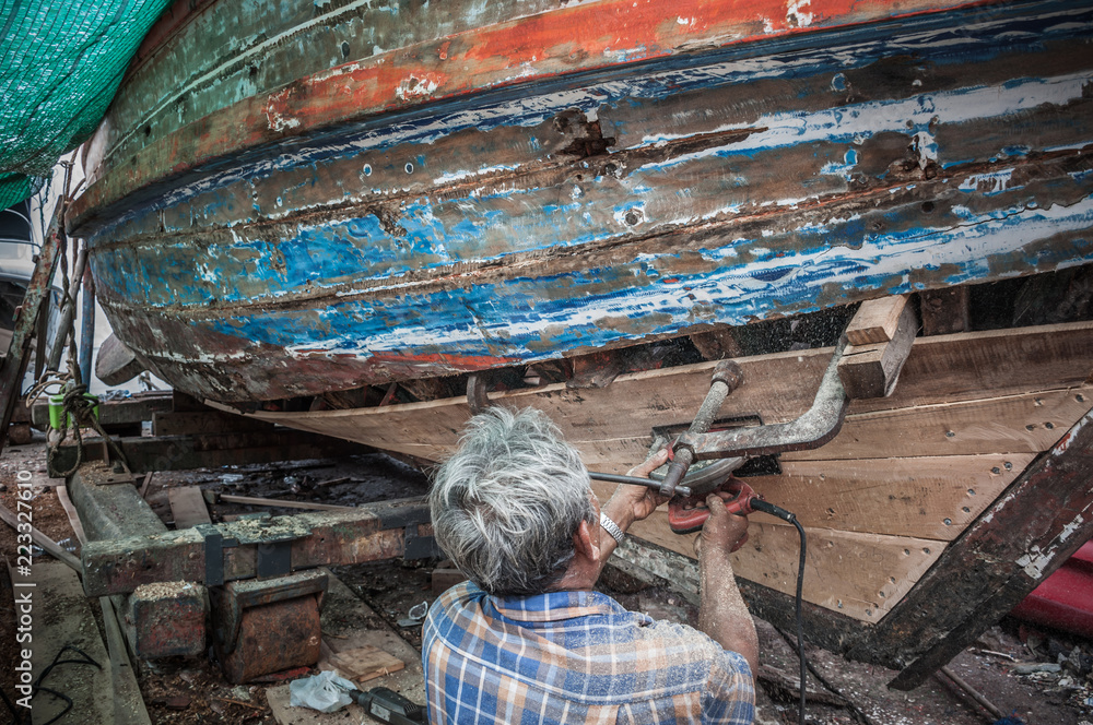 Mechanic maintenance old wood boat on beach with hand, fishery ...