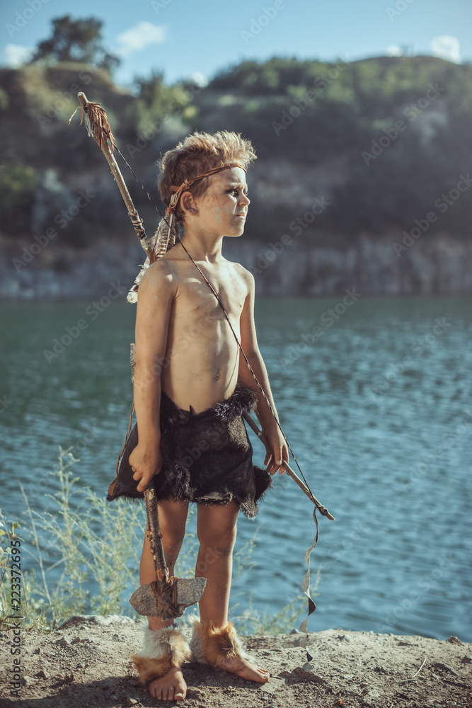 Caveman, manly man with stone axe and bow hunting near river ...