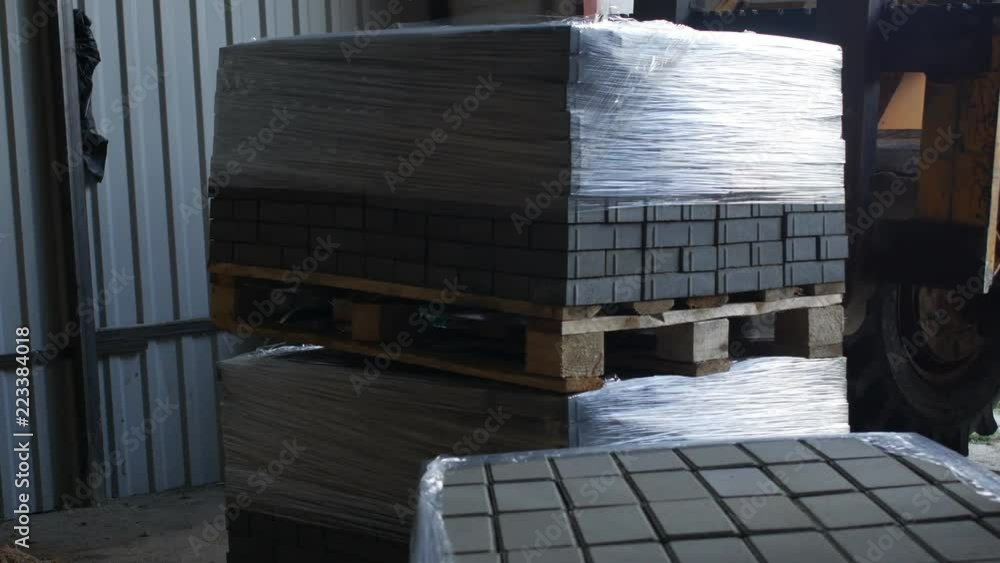 Loader loads finished interlocking concrete pavers Stock Video | Adobe ...