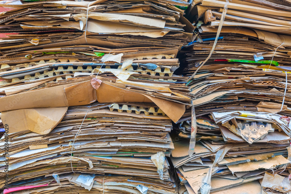Stack of cartons and paper waiting to be picked up by the garbage ...