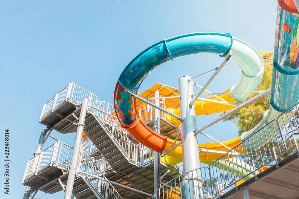 Vicky beautiful multi-colored water slide on the blue sky background ...