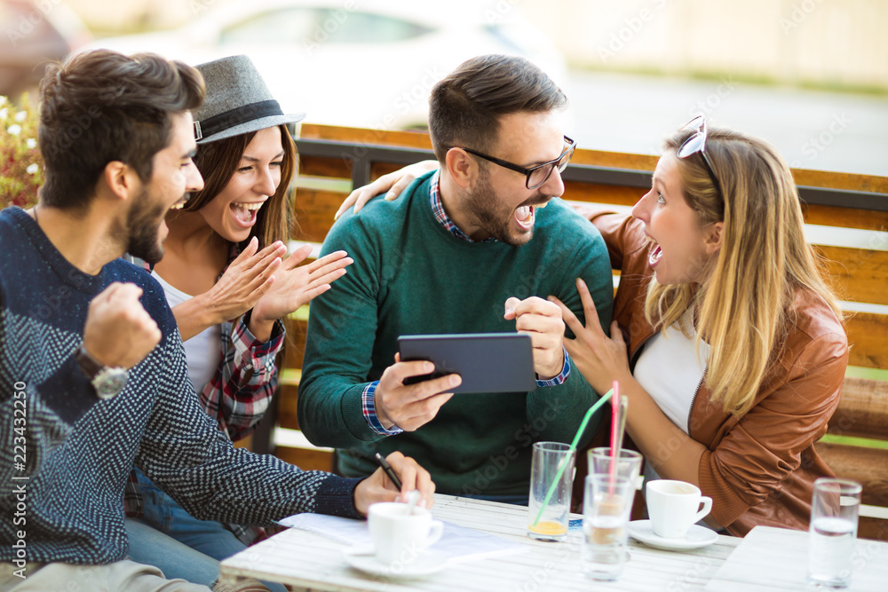 Group of four friends having a coffee together. Two women and two men ...