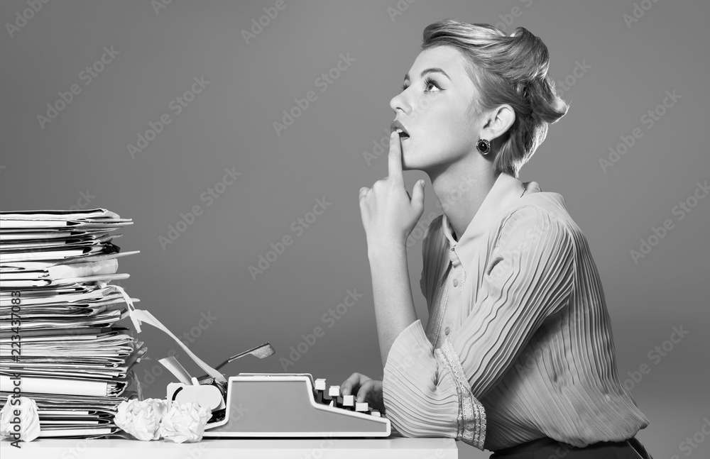 Young blonde female writer using typing machine Stock Photo | Adobe Stock