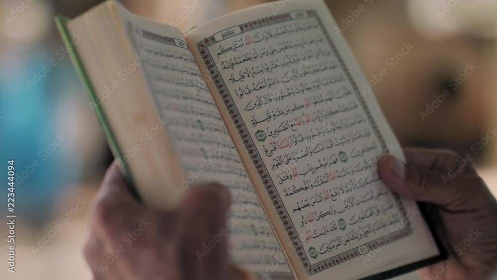 Man Reading a Quran, Man Reading a Koran, A Muslim man holding the holy ...