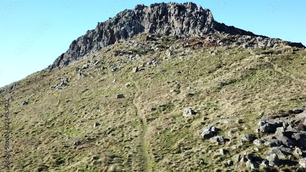 Steep rocky out crop, mountain Slow moving drone footage of a steep ...