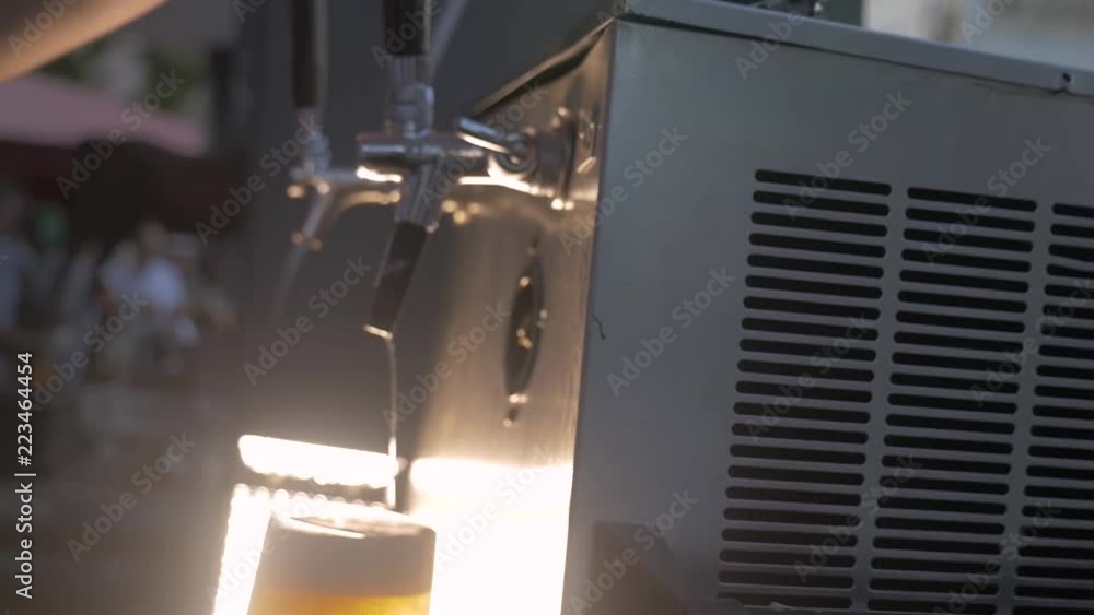 Tapping fresh beer with froth, from the side (wider) //close up, normal ...