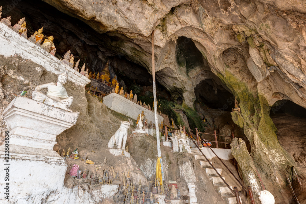 Hundreds of old and faded Buddha statues inside the Tham Ting Cave at ...
