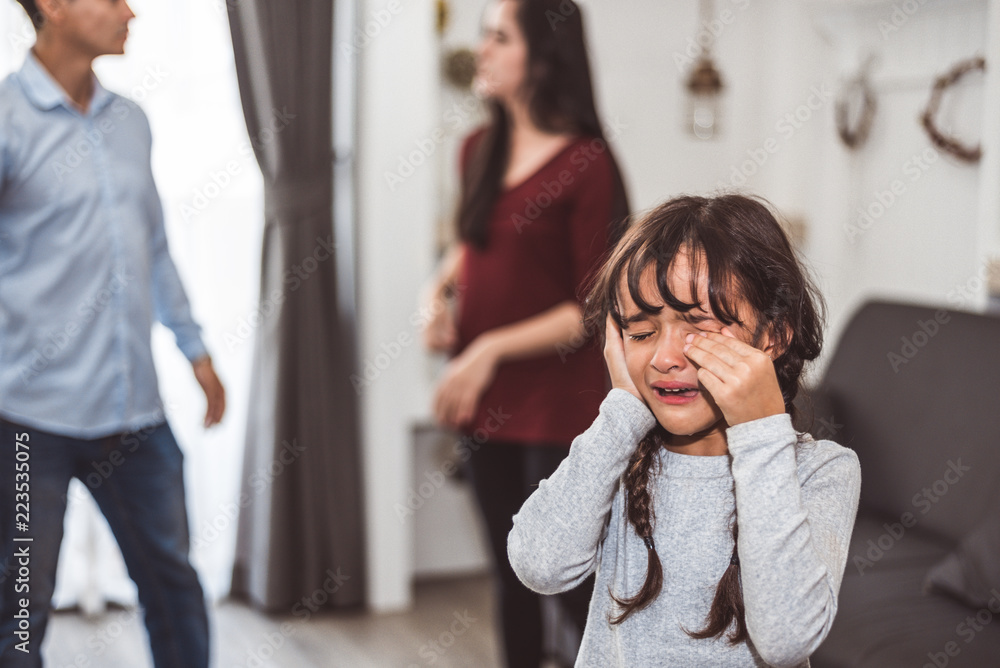 Little girl crying because of her parents quarreling. Girl abused with ...