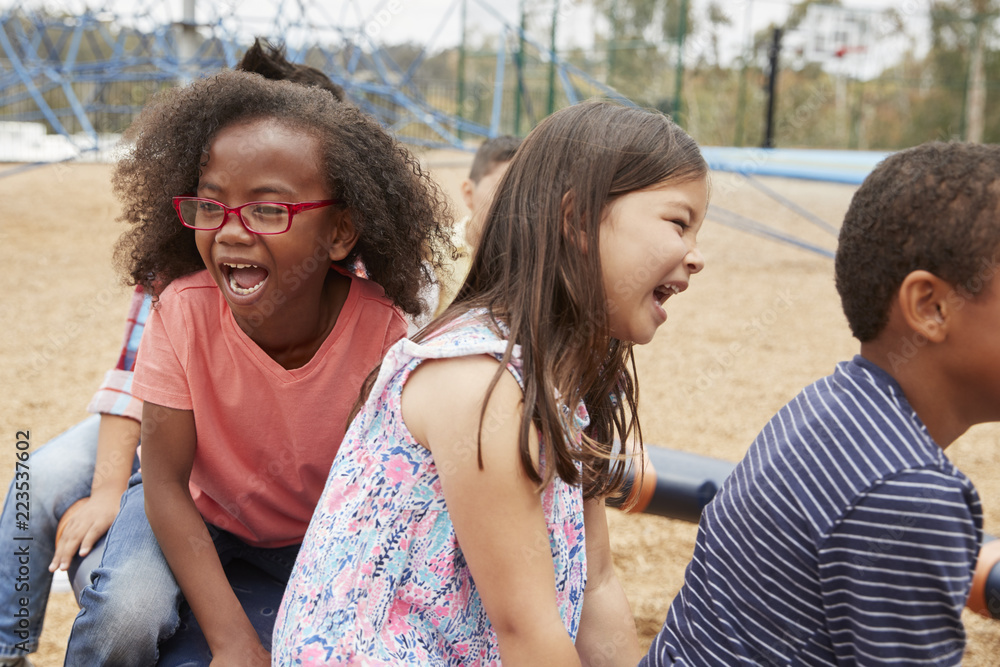 Elementary school kids playing in playground, close up Stock Photo ...