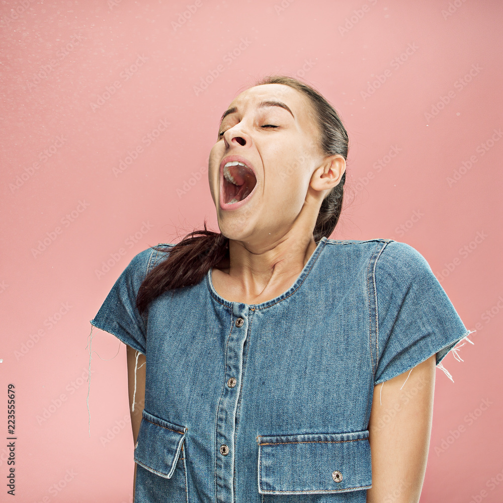 Young funny woman sneezing with spray and small drops, studio portrait ...