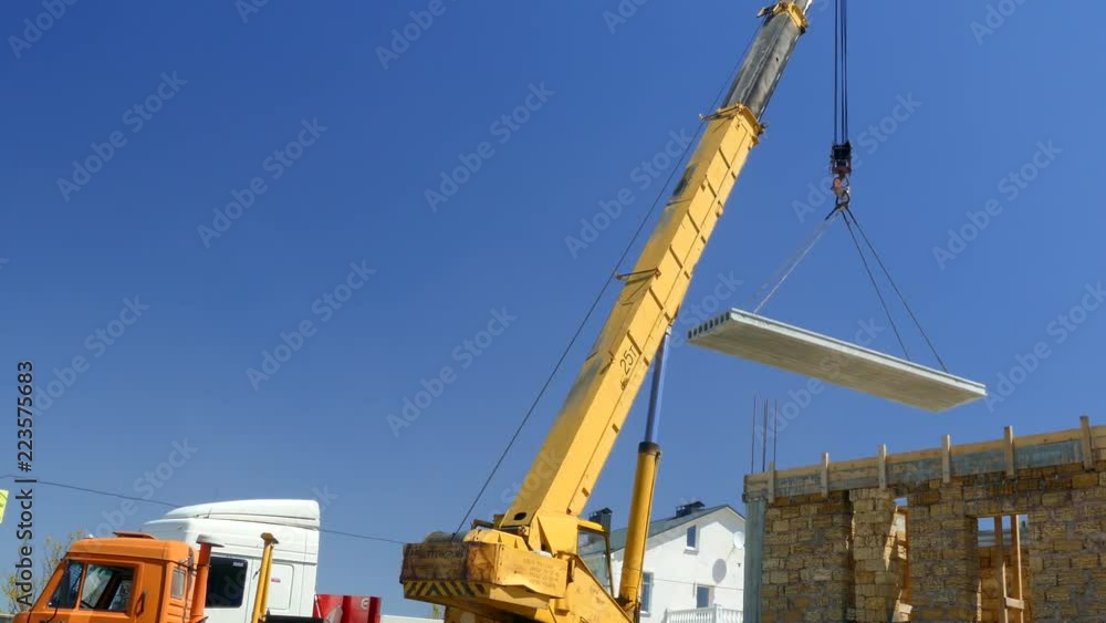 The mobile crane moves the concrete slab to the building. Stock Video ...