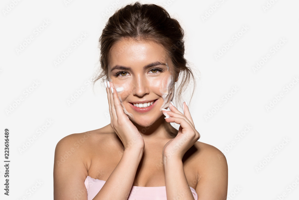 Portrait of cute smiling woman with foaming cleanser. Attractive joyful ...