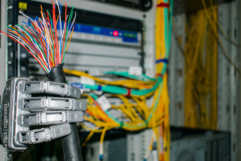 Damaged utp cable is in the robot's hand. A mechanical robot arm holds ...