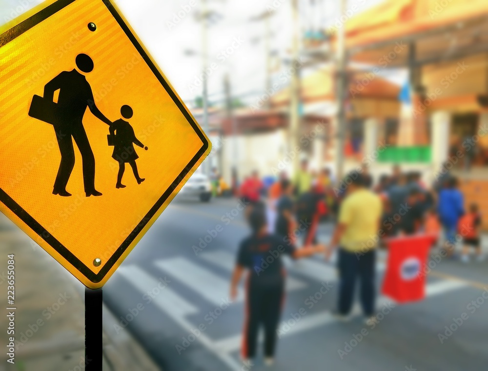 Focus on traffic warning school road sign and blurred background of ...