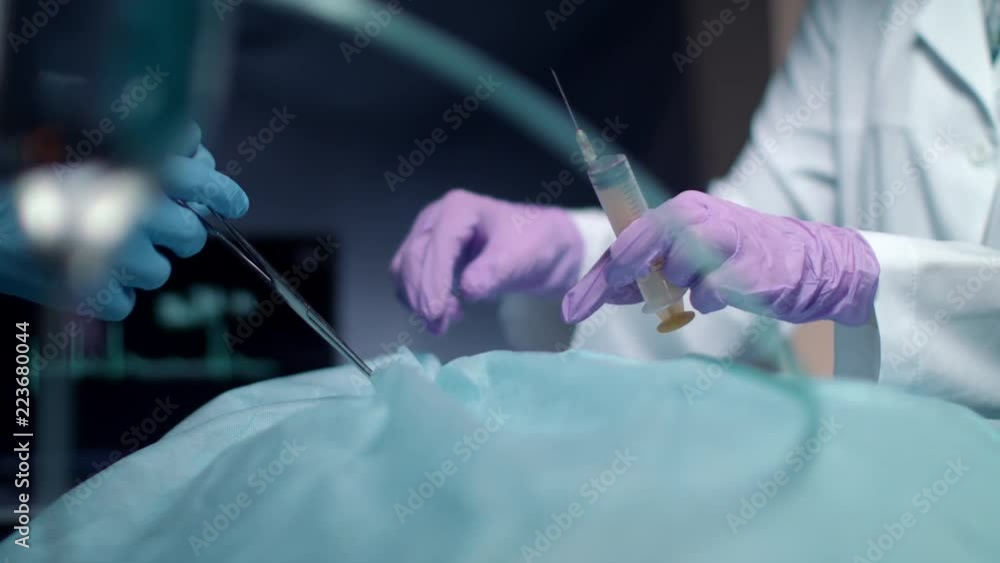 Surgeon operating process. Close up of anesthesiologist hand preparing ...