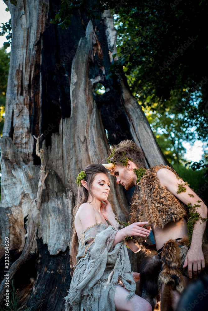 Young couple of elves in love standing in magical forest outdoor on ...