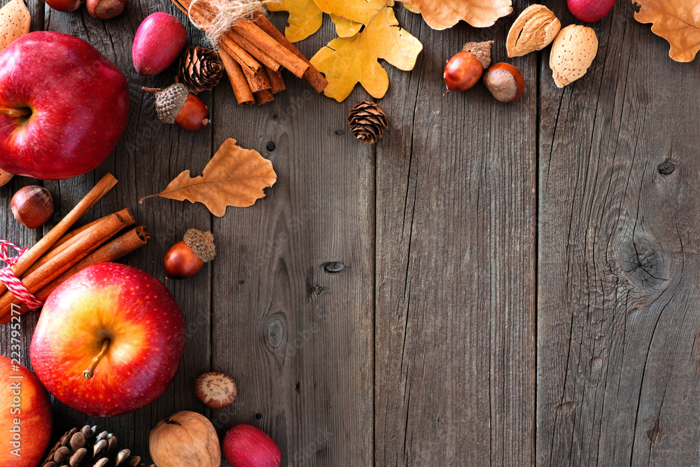 Autumn corner border of apples and fall ingredients on a rustic wood ...