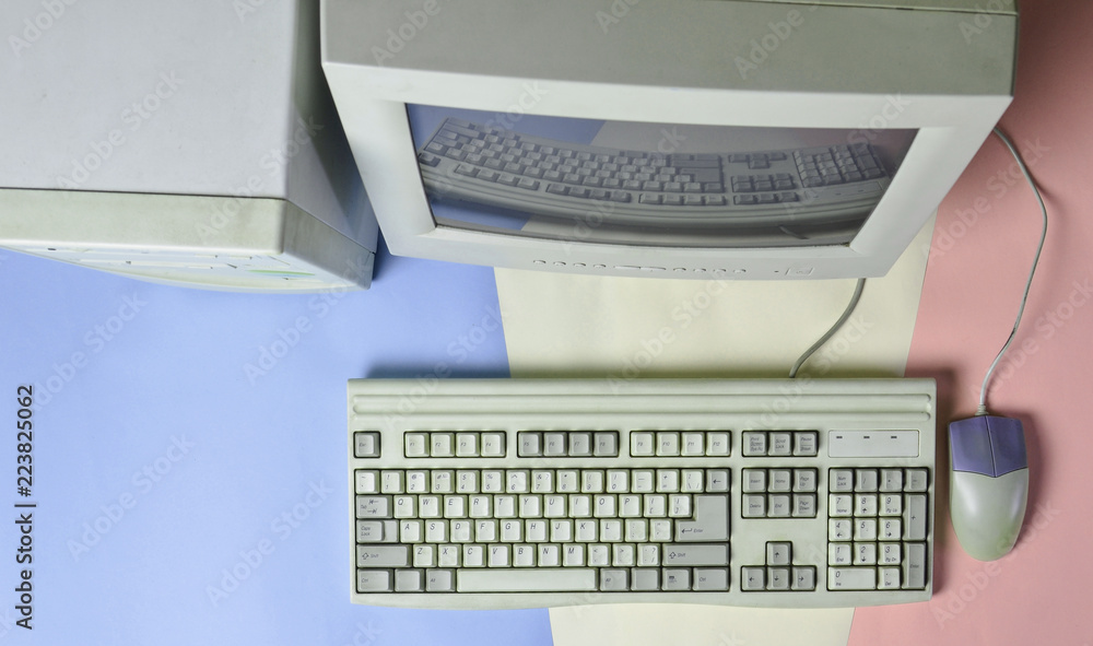 Retro stationary computer on colored background. Monitor, system unit ...