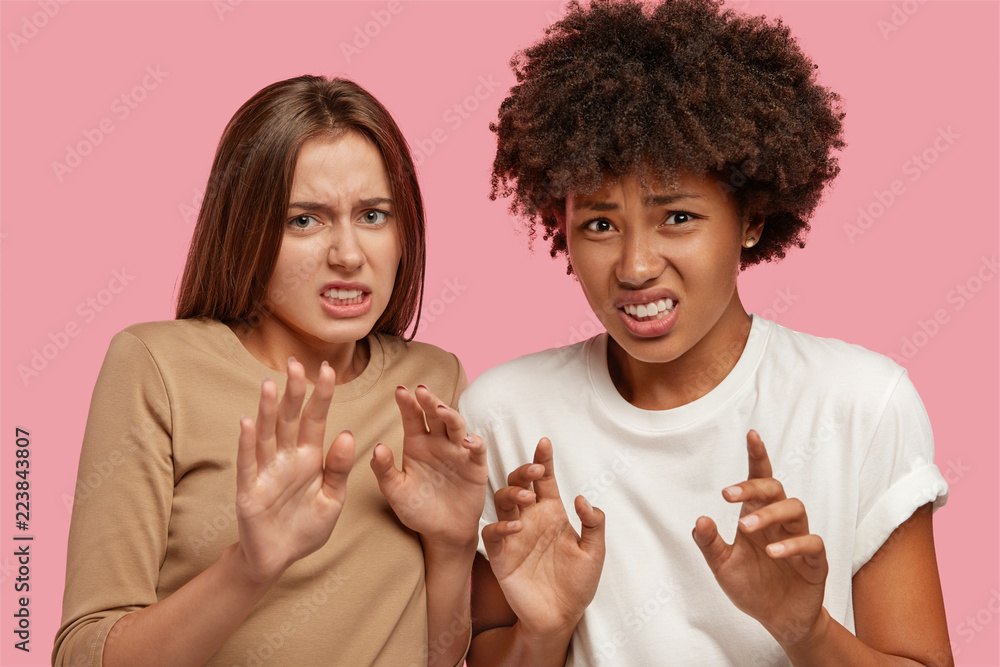 Young diverse women feel squeamish, see something unpleasant, express ...