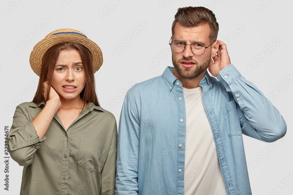 Photo of confused young girlfriend and boyfriend scratch head in ...
