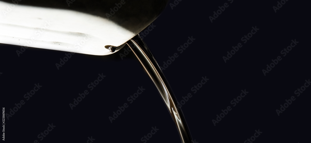 The process of replacing old engine oil in a passenger car. Used oil ...