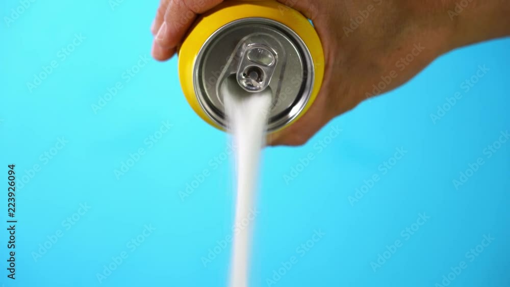Hand holding soda can pouring lots of sugar in metaphor of sugar ...