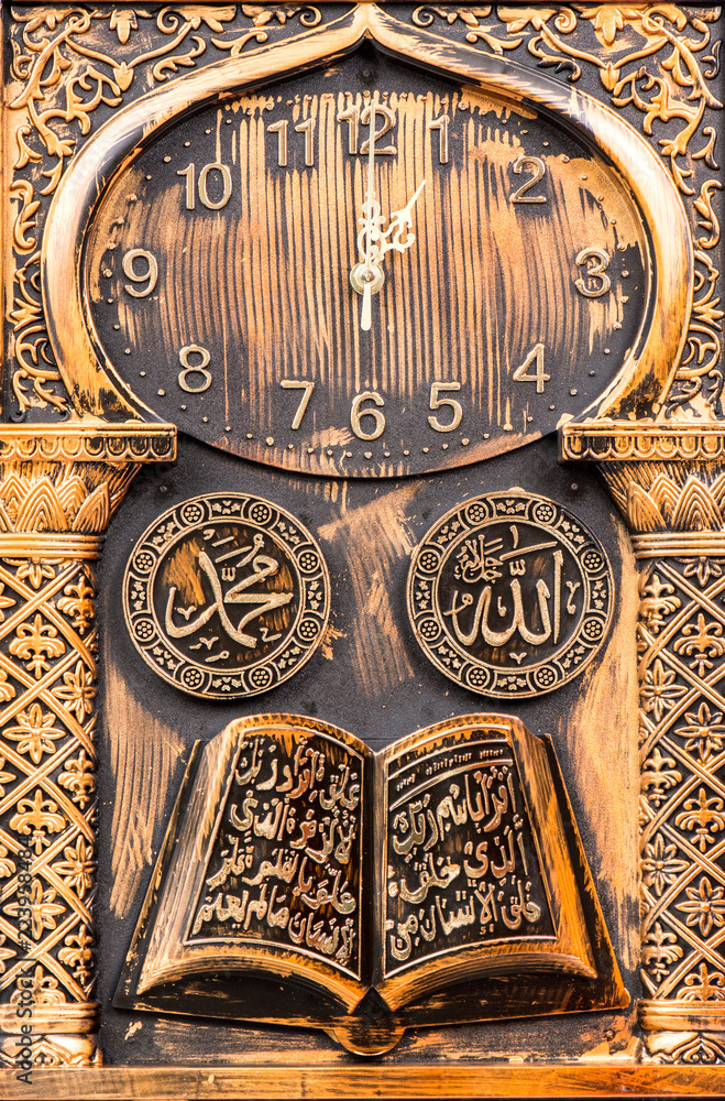 Old clock indicating time for prayers, on mosque silhouetted for holy ...